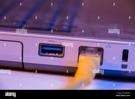Closeup Of Ethernet Cable Plug Inserted Into Port On The Side Of A Laptop Stock Photo Alamy