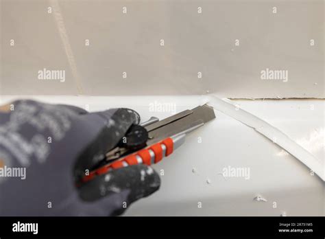 Workmen Remove Old Silicone Grout From Bathtub With Cutter Knife Detail Stock Photo Alamy