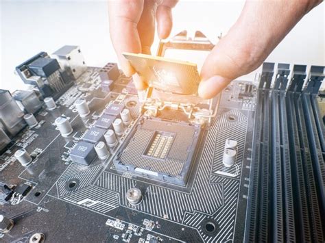 Premium Photo Hold The Cpu Handle And Insert It Into The Cpu Slot On The Motherboard Its An