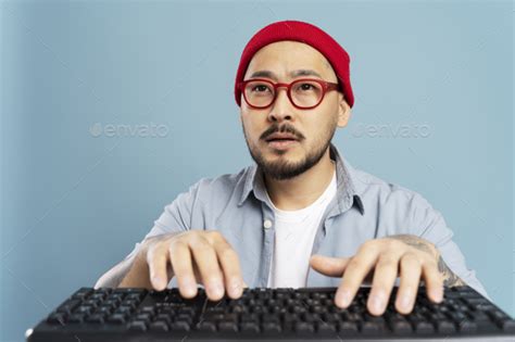 Korean Programmer Coding Typing On Keyboard Working Online Isolated On Blue Background Stock
