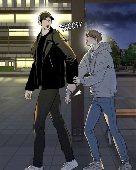 Two People Standing Next To Each Other In Front Of A Building With The