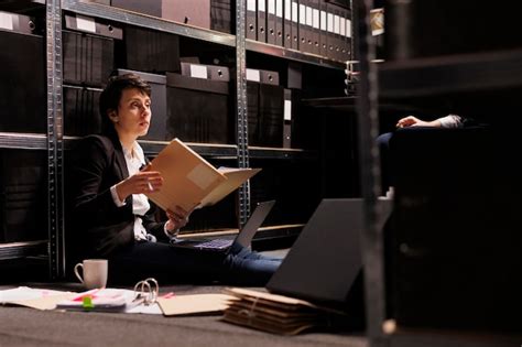 Premium Photo Overworked Investigator Sitting On Floor In Arhive Room