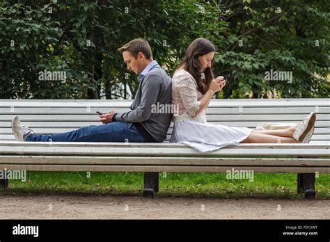 Lovers Ignore Each Other On A Date By Reading Messages In Their Phones