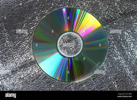 Closeup Of A Compact Disk With Colorful Glare On A Flat Surface With