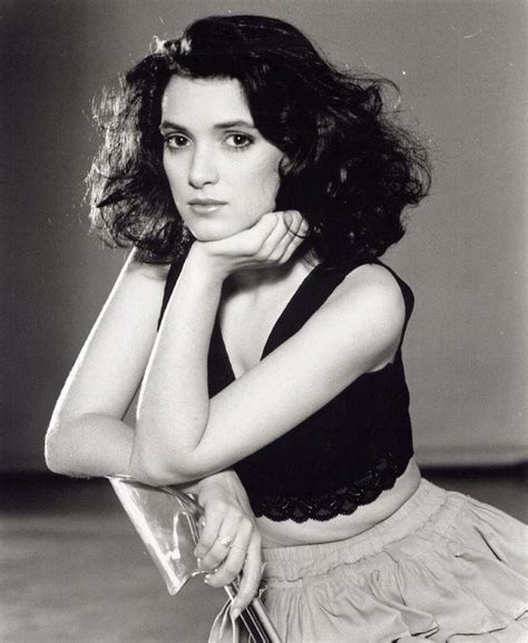 A Black And White Photo Of A Woman Holding A Purse