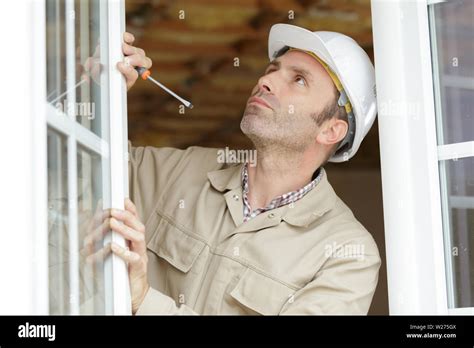 Repairman Fixing Window Frame In Room Stock Photo Alamy