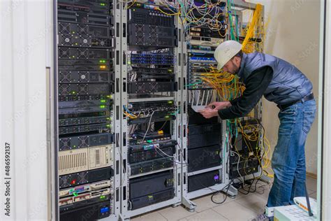 A Technician Works In A Server Room Support For The Network Information Infrastructure Of The
