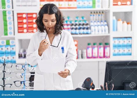 Young Woman Pharmacist Reading Paper At Pharmacy Stock Image Image Of
