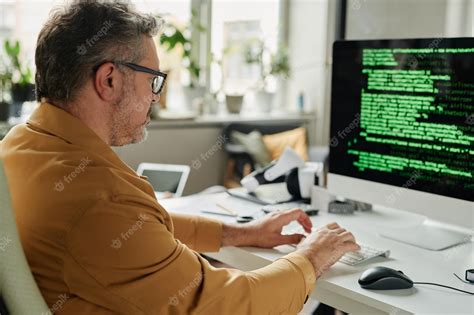 Premium Photo Side View Of Mature Serious Male It Engineer Typing On Computer Keyboard