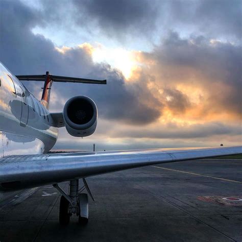 Fighter Jet Tail On Tarmac With Clouds Background