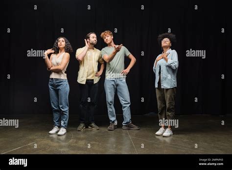 Redhead Man Standing With Hands On Hips And Pointing With Hands Near