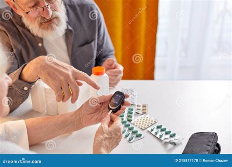 Closeup Hands Woman And Man Measuring Glucose Test Level Checking On Finger By Glucometer