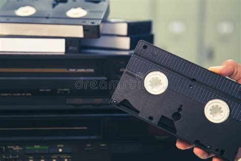 Close Up Hand Chooses Video Cassette Tape Vhs On Video Tape Player
