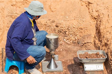 Worker Using Equipment For Testing Laboratory Field Density Test Sand