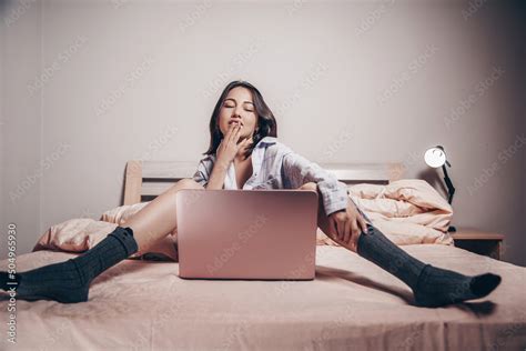 A Young Asian Webcam Model Girl Is Sitting In Front Of A Laptop With