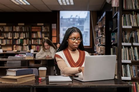 Young Student Working On Assignment Free Photo