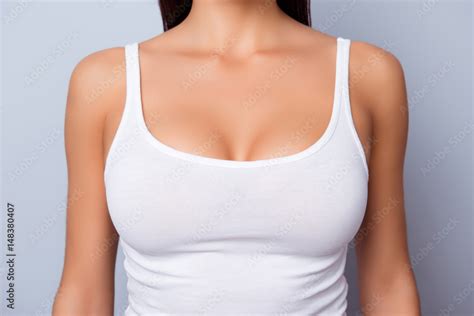 Close Up Of Perfect Lady`s Chest With Bronze Skin In White Singlet On