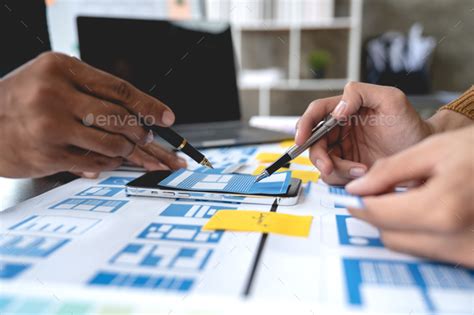 Ux Developers Ui Designers Asian Group Data Researchers Brainstorm On Tabletop Mobile App