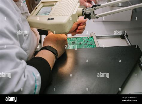 Female Computer Expert Professional Technician Examining Board Computer In A Laboratory In A