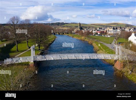 View Of Suspension Bridge Crossing River Tweed In Town Of Peebles In