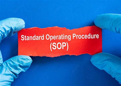 Standard Operating Procedure Sop For Covid An Image Of A Doctors Hand Holding The Document