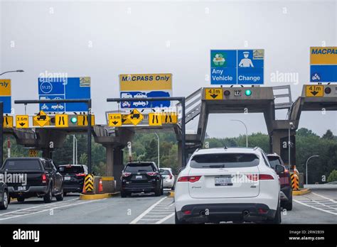 A Car Enters A Toll Plaza Macpass Banner At A Toll Plaza Mac Pass Is Electronic Tolling System