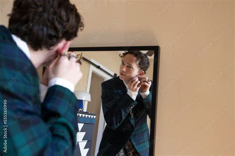 Non Binary Caucasian Person With Short Hair Getting Dressed In Mirror Stock Photo Adobe Stock
