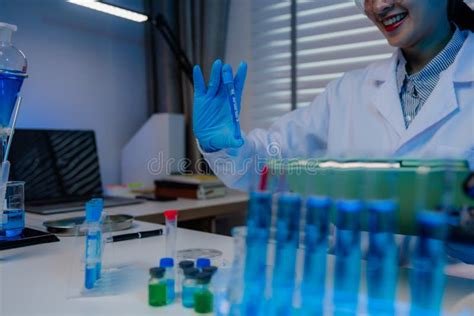 A Female Scientist Is Experimenting With Chemicals In A Lab Science Experiments Often Require A