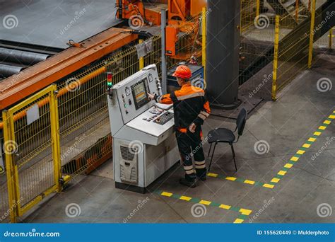 Factory Worker Programming Cnc Machine In Metalworking Workshop