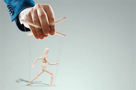 Premium Photo Male Hand Puppeteer Controls The Puppet Puppet With Strings A Doll On Her