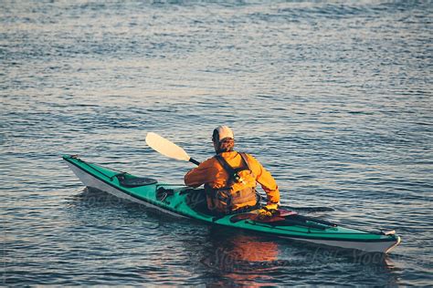 Man Sea Kayaking In Puget Sound At Dusk By Stocksy Contributor