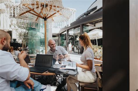 Startup Team In Business Meeting Discussing Brainstorming And Strategizing In An Outdoor Cafe