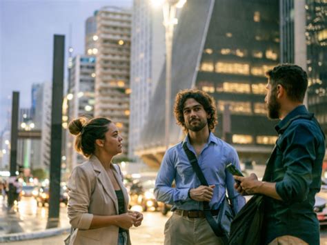 Three People Having A Conversation On A City Street