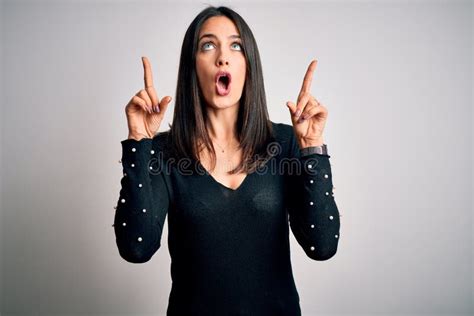 Young Brunette Woman With Blue Eyes Wearing Black Casual Sweater Over