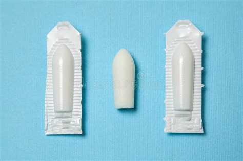Suppository For Anal Or Vaginal Use On A Blue Background Candles For Treatment Of Hemorrhoids
