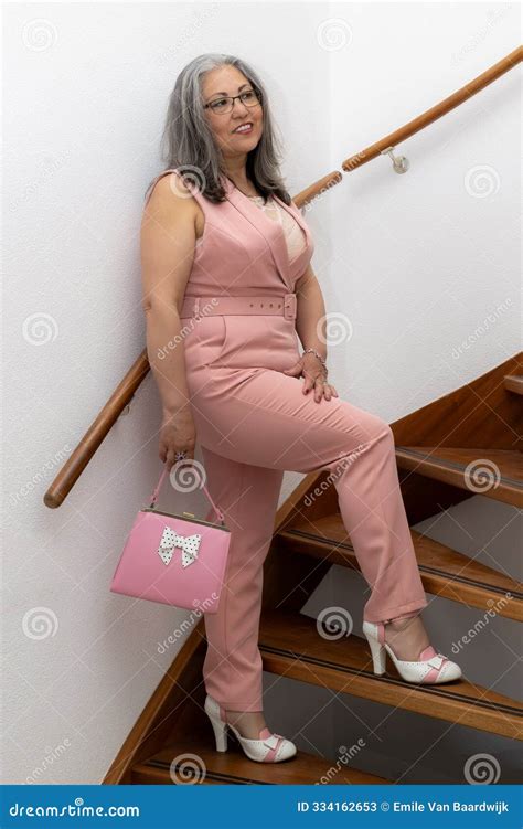 Happy Smiling Mature Woman Standing On Wooden Ladder Leaning Stock