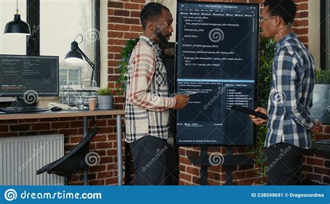 Team Of Software Engineers Leaving After Analyzing Source Code On Wall