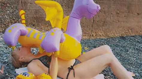 Alla Inflates A Rare Inflatable Magic Dragon With Her Mouth And Floats On It In The Sea