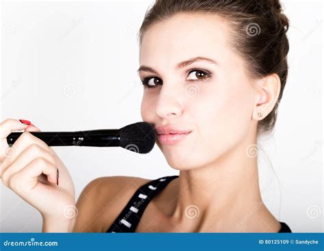 Female Model Applying Makeup On Her Face Beautiful Young Woman