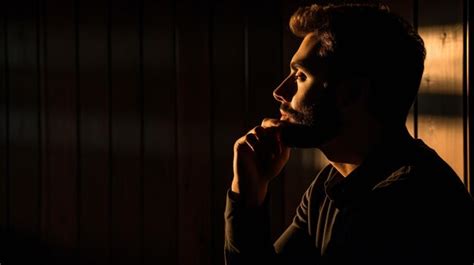 Premium AI Image A Man In A Dark Room With A Cell Phone