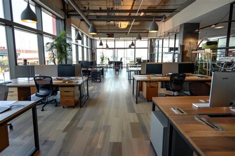 A Modern Open Floor Plan Office With Spacious Desks And Collaborative