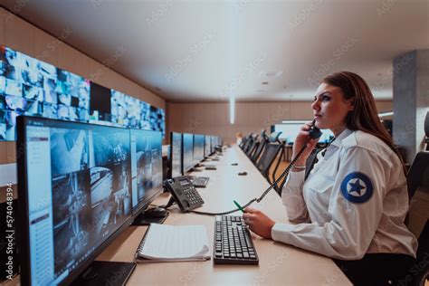 Female Security Operator Working In A Data System Control Room Offices Technical Operator