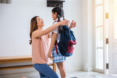 Premium Photo Loving Mother And Schoolgirl With Backpack Before First Day