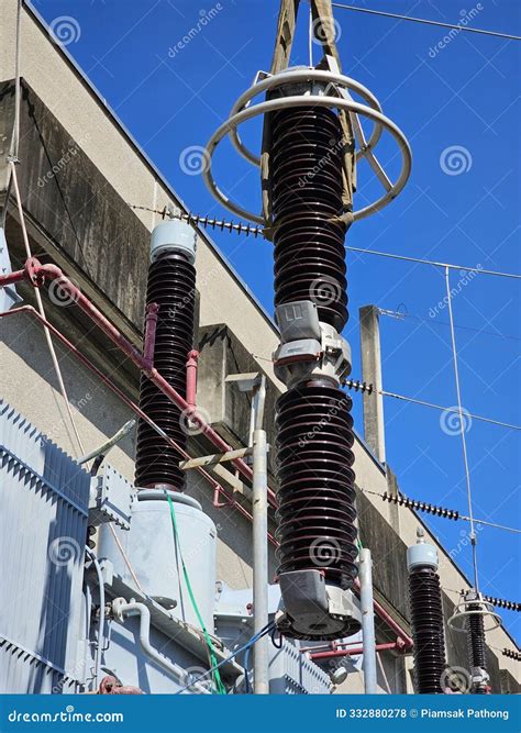 A Close Up Of A Worker Using A Crane To Install A Large Ceramic Electrical Insulator On A High
