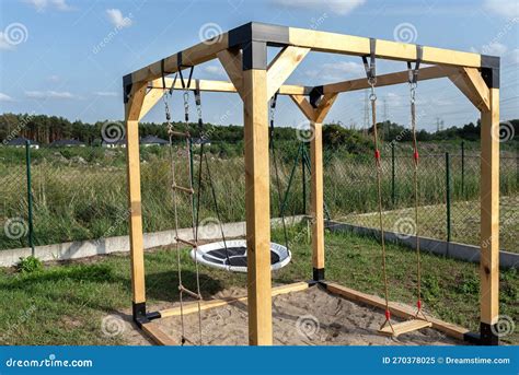 A Modern Cube Playground Made Of Wood And Metal Corners Standing In The Yard Behind The House
