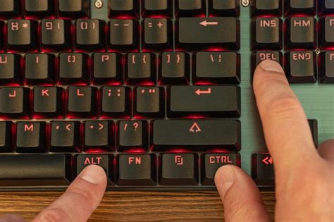 Premium Photo Keyboard Shortcut Ctrl Alt Del Is Pressed With A Male Hand
