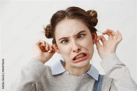 Young Woman Making Goofy Face Being Naughty Prankster With Twisted Mouth Grimacing Female