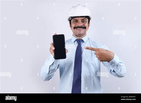 Construction Worker Pointing Towards The Mobile Smart Phone The