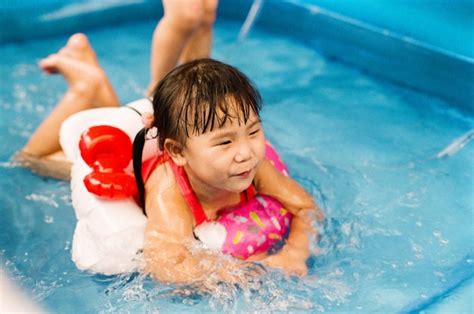 Premium Photo High Angle View Of Girl Swimming In Wading Pool