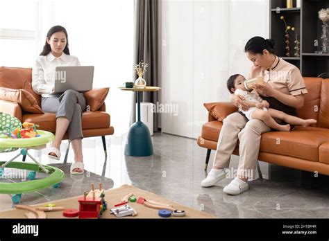 Nanny taking care of baby girl Stock Photo - Alamy